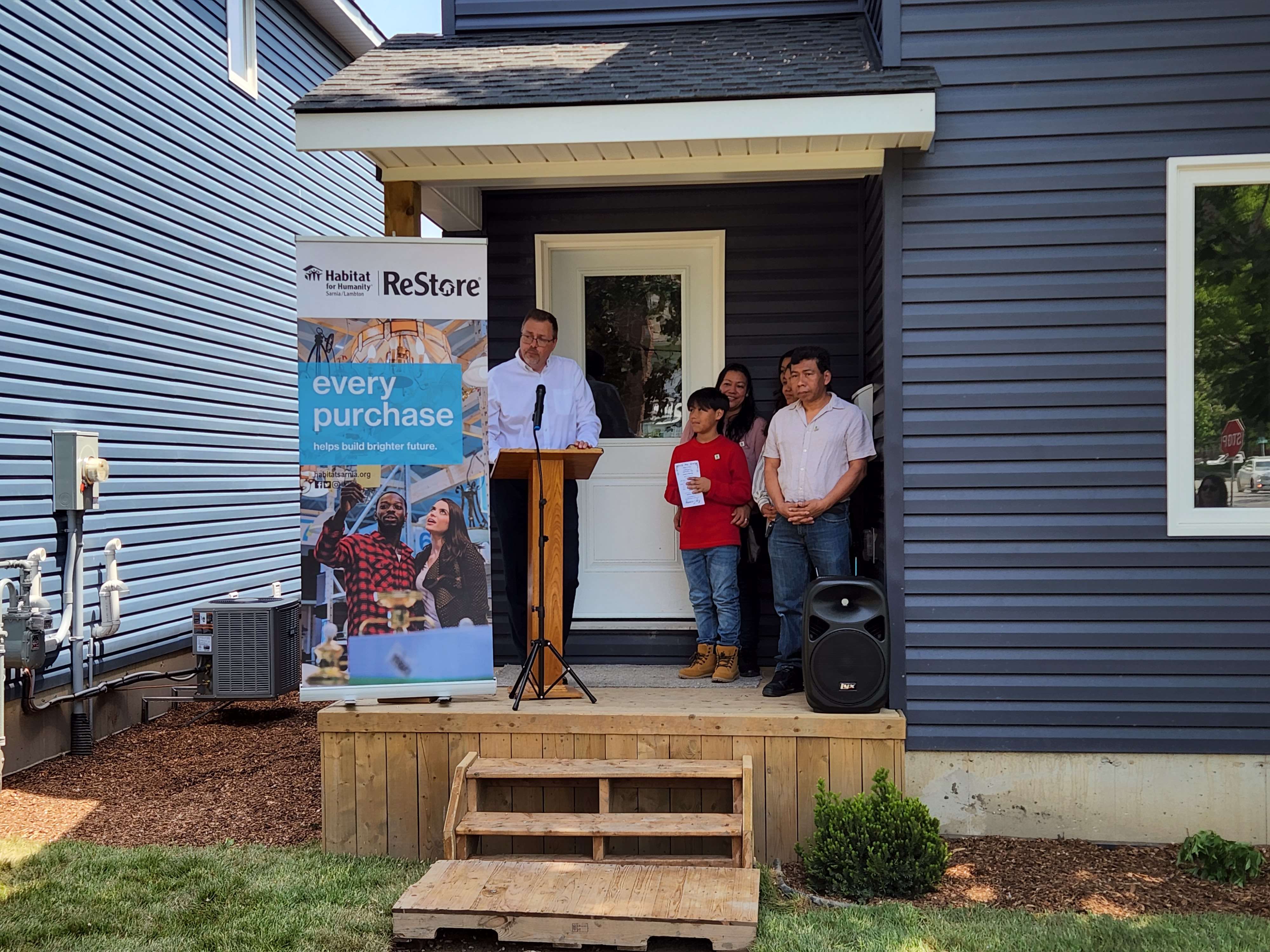 Two families receive keys to new Habitat homes